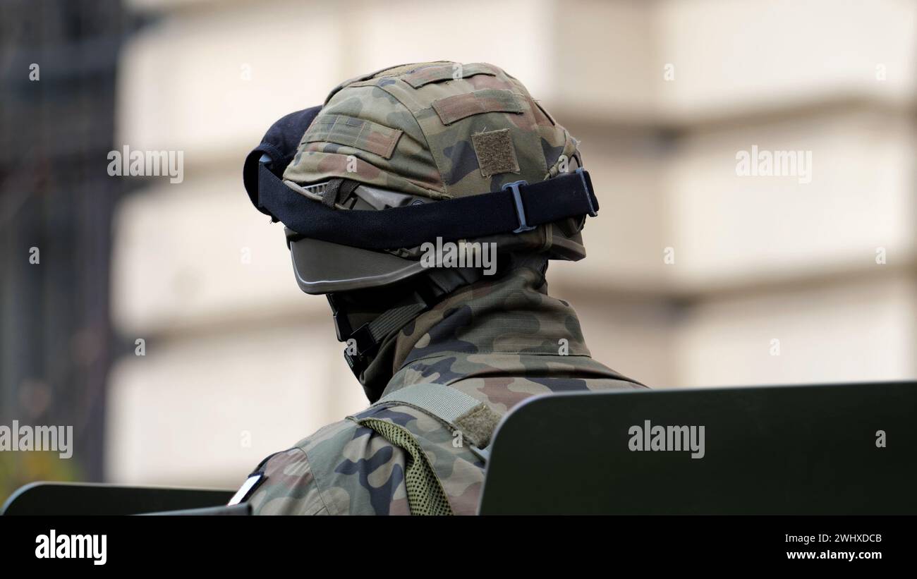 One single anonymous soldier in a full generic green camo camouflage ...