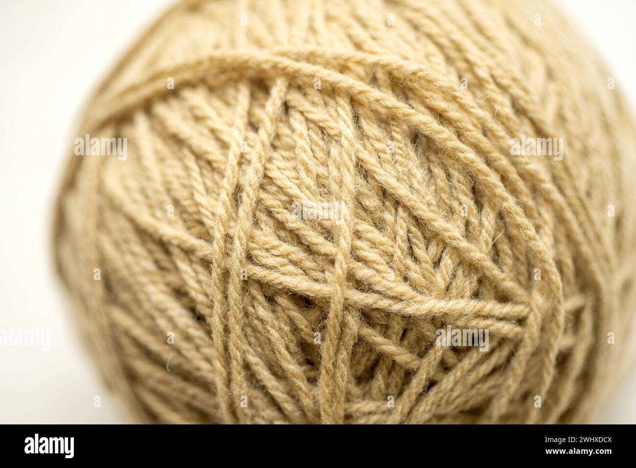 Round brown ball of tangled string object, cat toy, detail, extreme ...