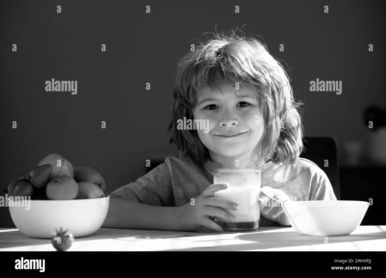 Child with glass of milk eating healthy food Stock Photo - Alamy