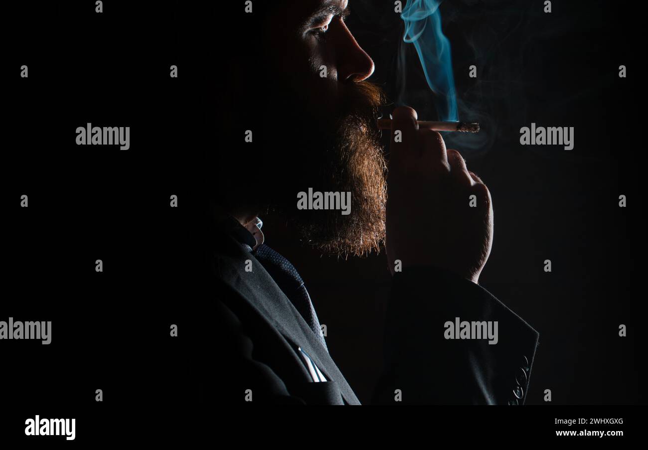 Dark shadow on face young man smoking over a black background. Man ...