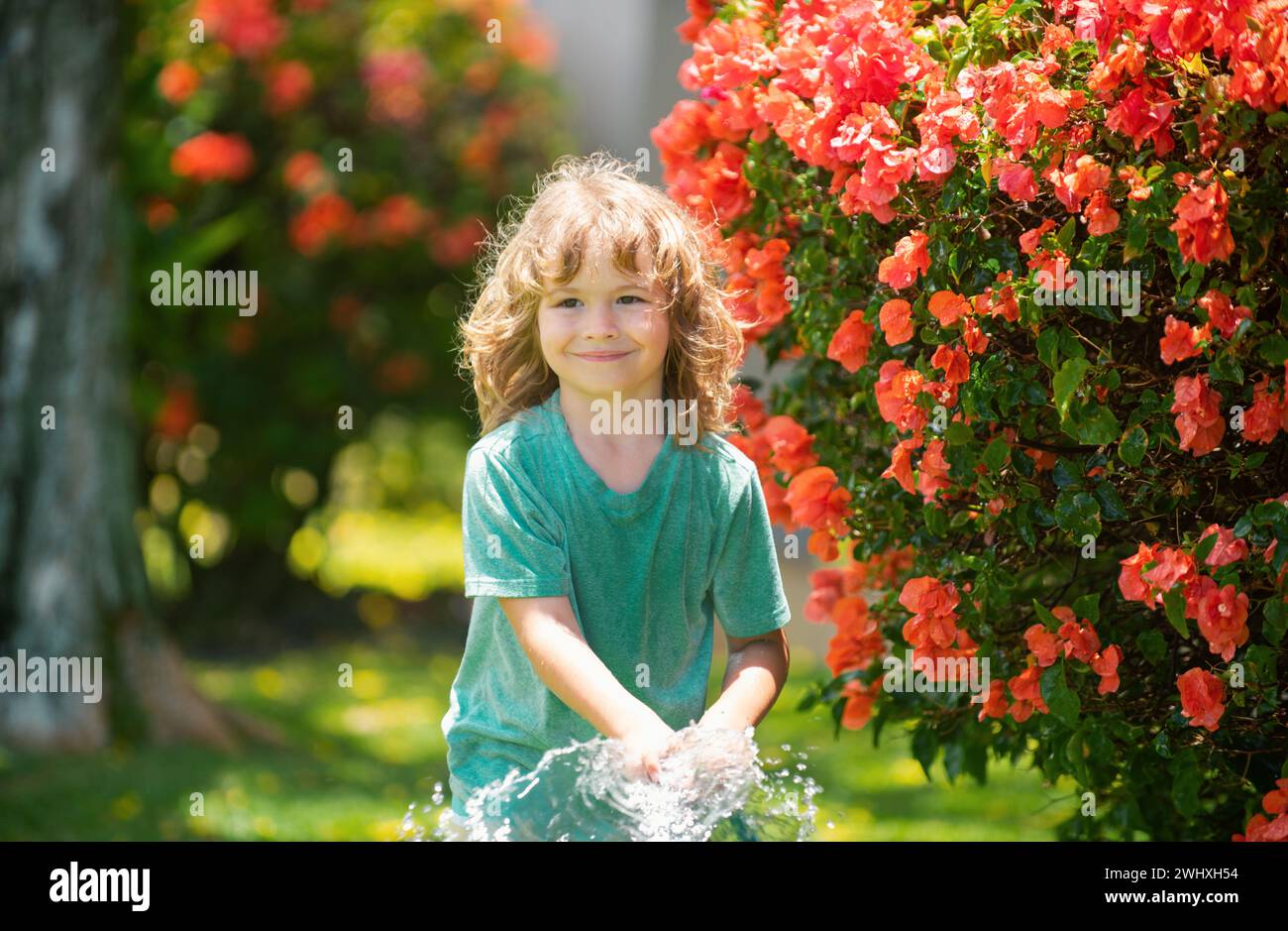 Child is watering the plant outside the house, concept of plant growing learning activity for ...