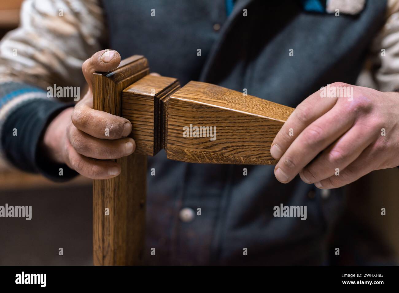 The carpenter glues the details of the cabinet leg closeup Stock Photo ...