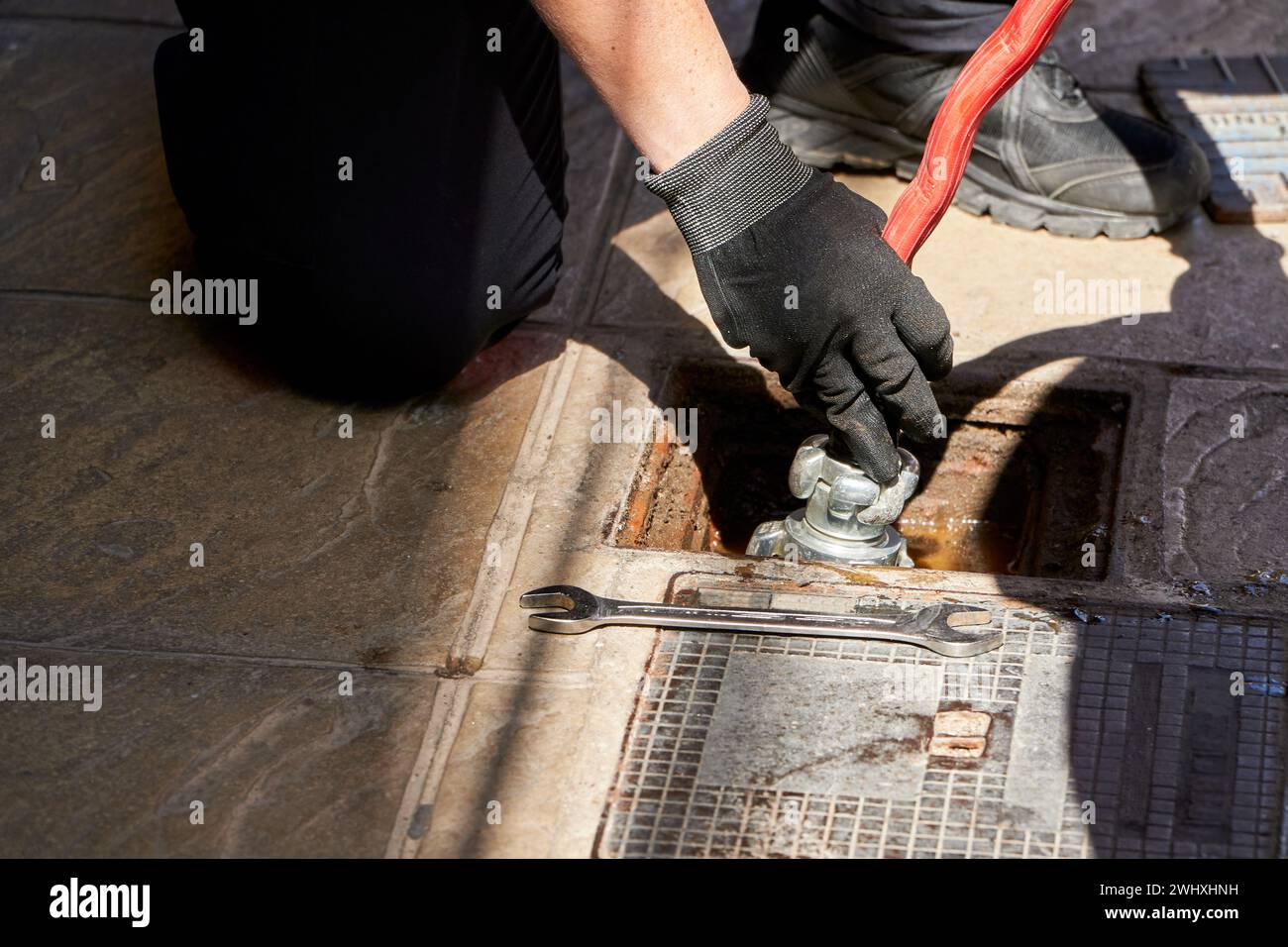 Firefighter connecting hose to a fire hydrant on the street in order to ...