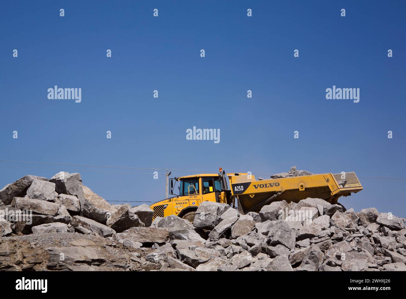 Volvo A25D loader loaded with large dynamited rocks at new road ...