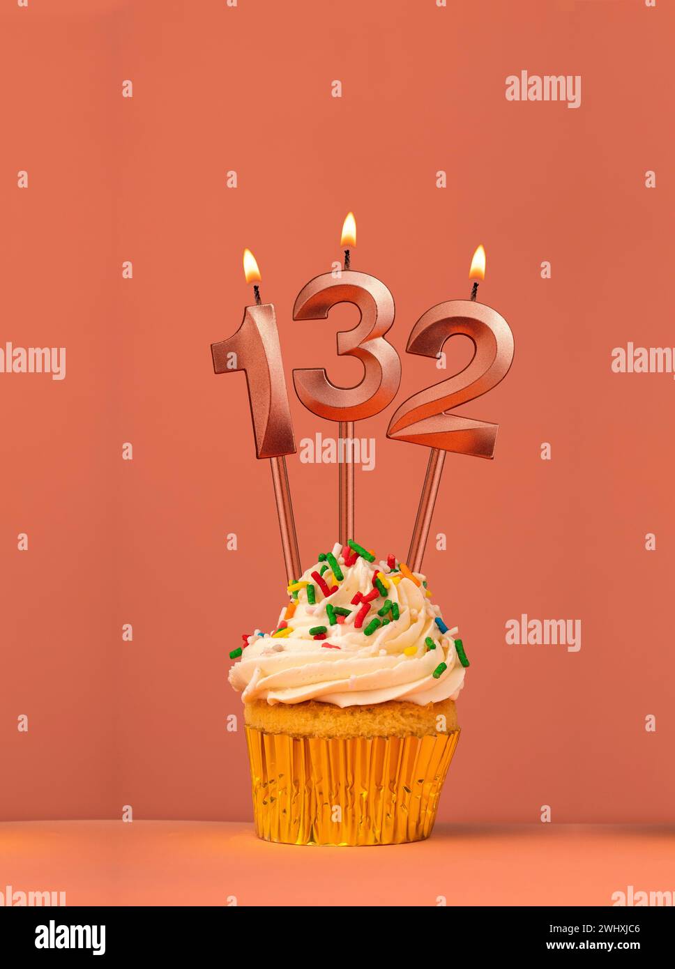 Birthday cupcake with candle number 132 - Coral fusion background Stock ...