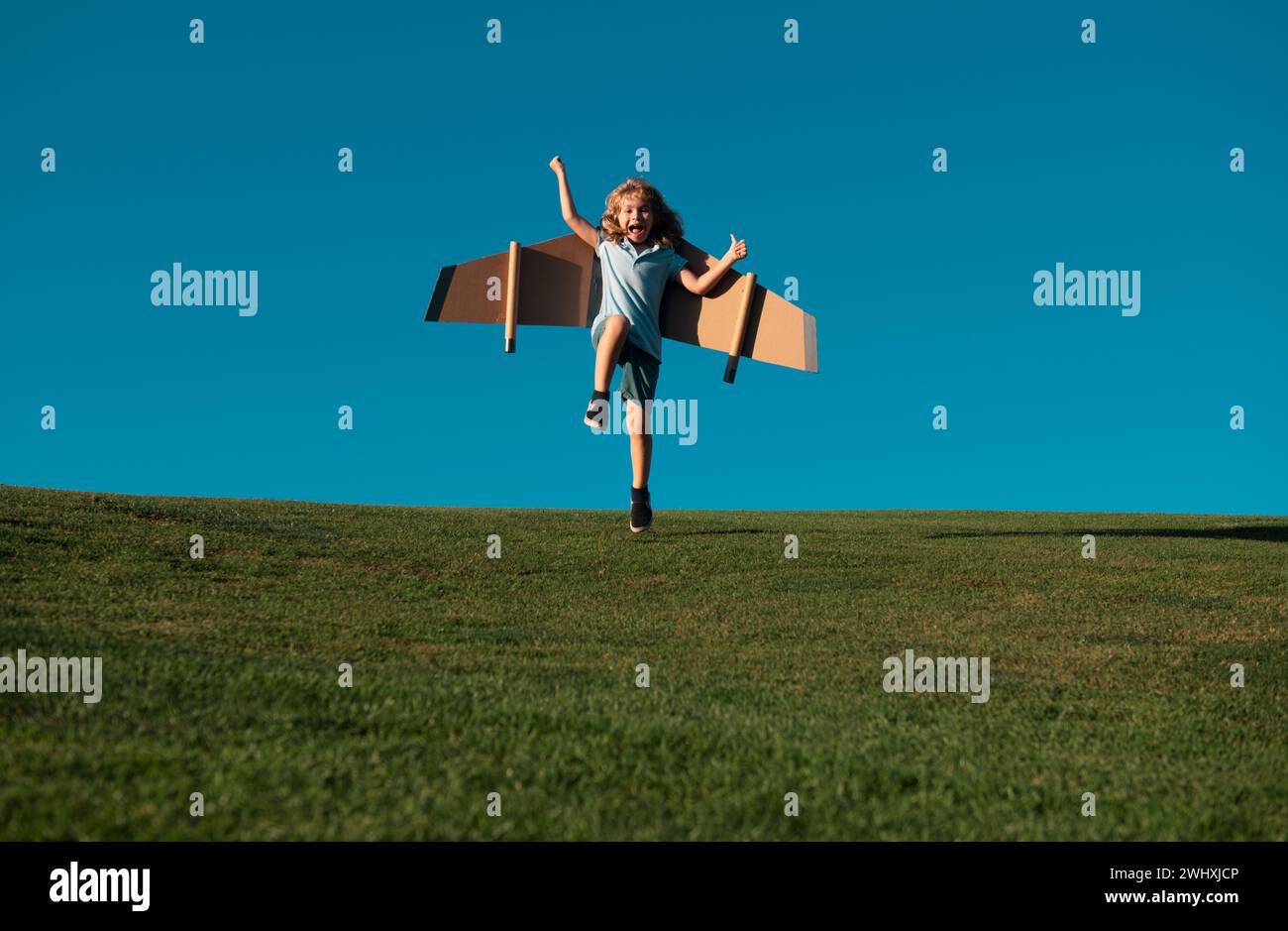 Child jumping and running in park, imagination dream to be pilot ...