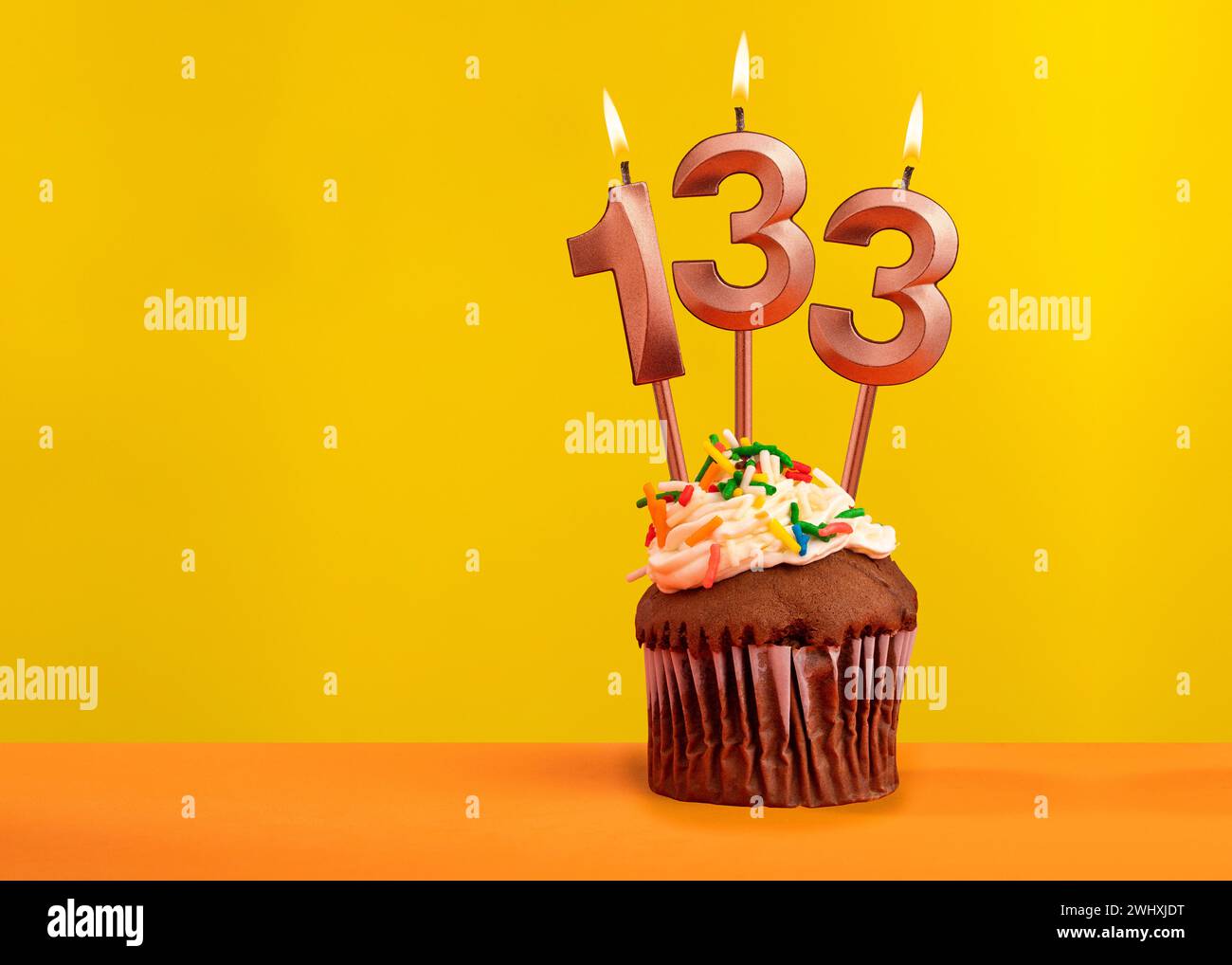 Candle with flame number 133 - Birthday card on yellow background Stock ...