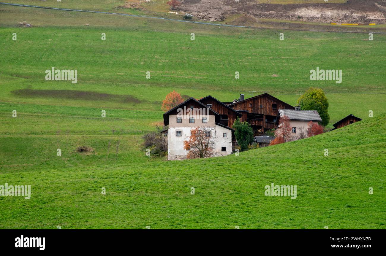 Traditional wooden cottage mountain houses in the green field in the ...