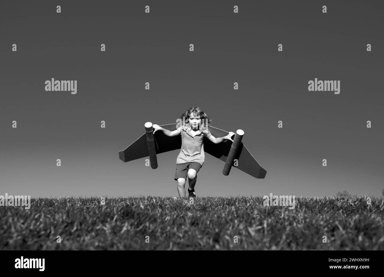 Little child plays astronaut or pilot. Child on the background of blue ...