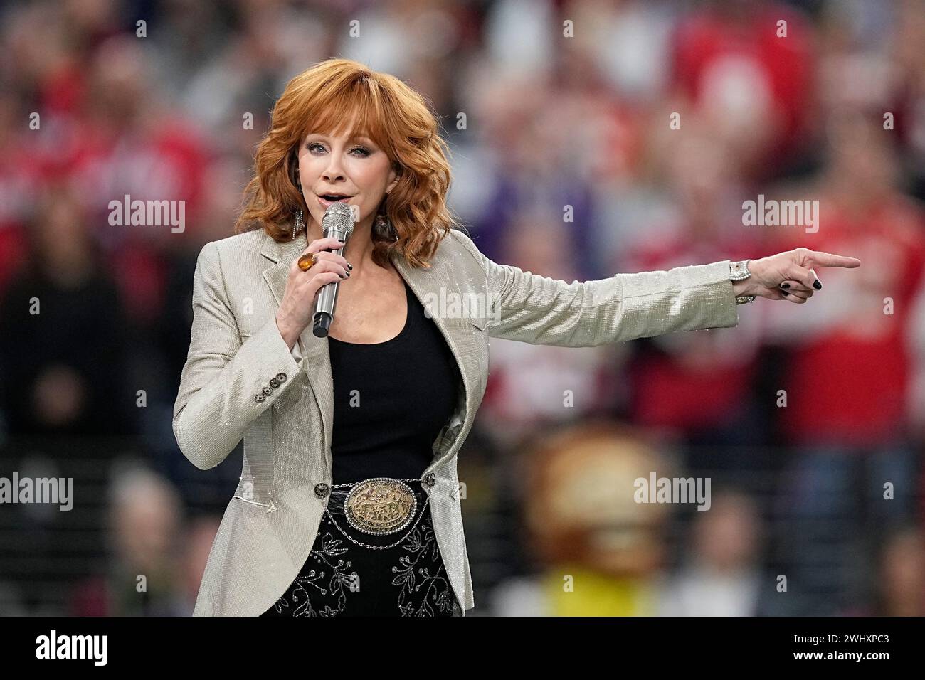 Reba McEntire performs the national anthem before the NFL Super Bowl 58 football game between ...