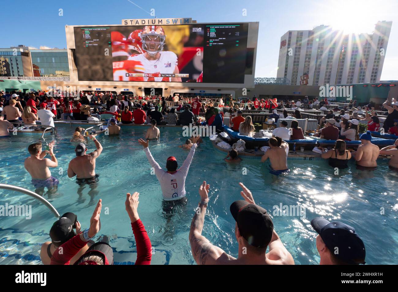 Fans watch the Super Bowl 58 NFL football game from a pool on top of ...