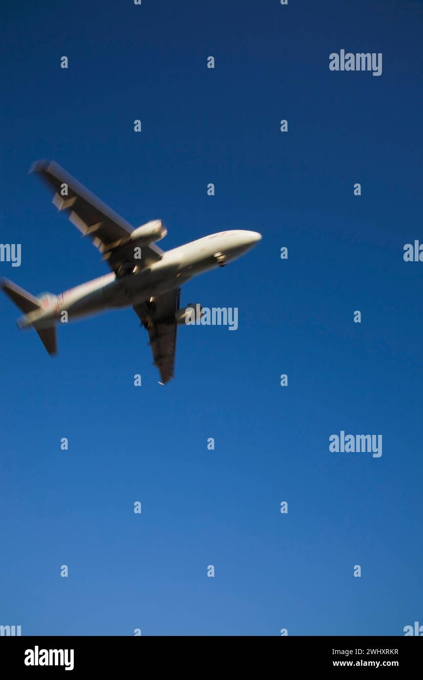 Underside view of commercial jet airplane in flight with motion effect ...