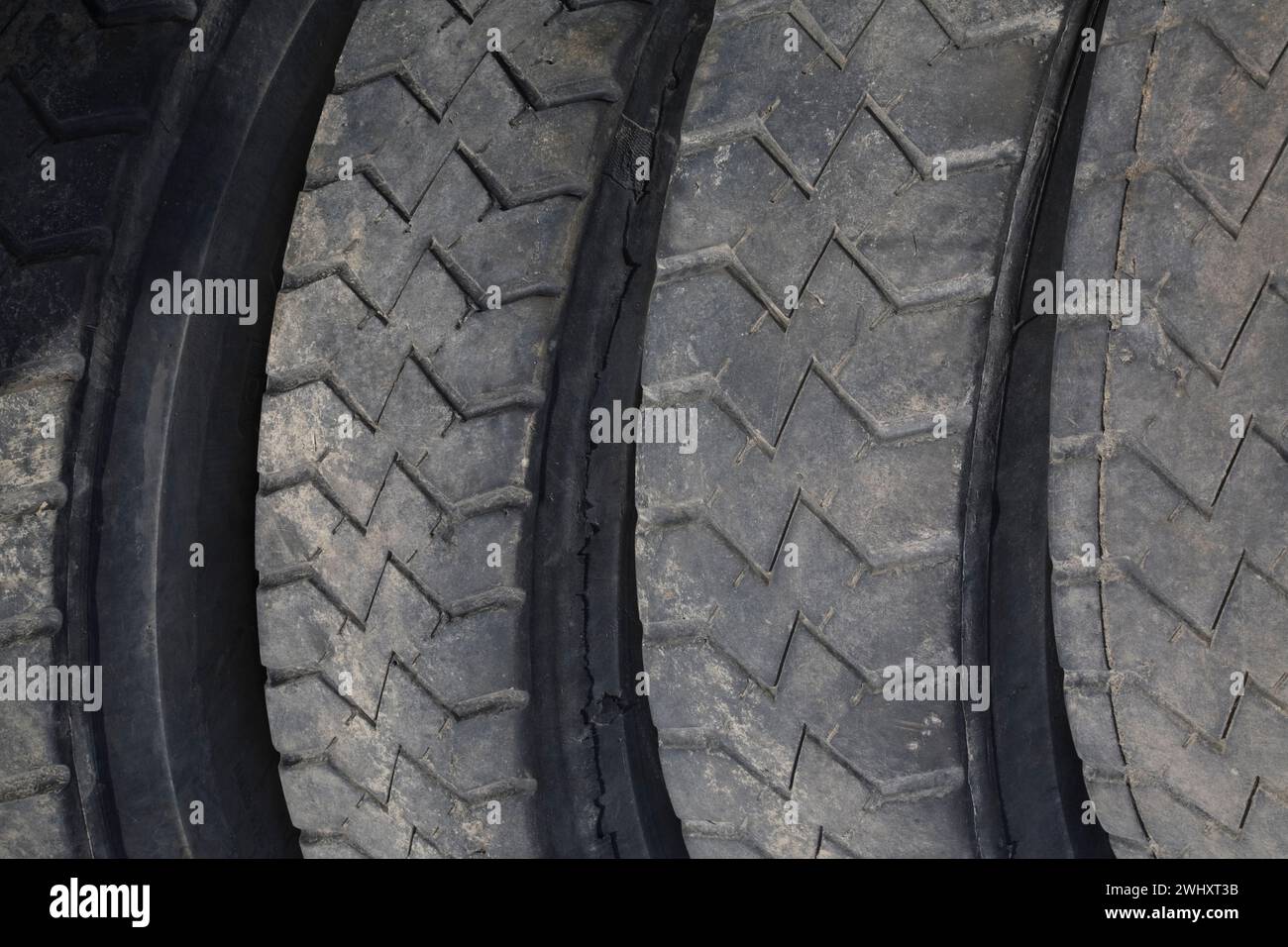 Close-up of black rubber truck tires with worn threads Stock Photo - Alamy