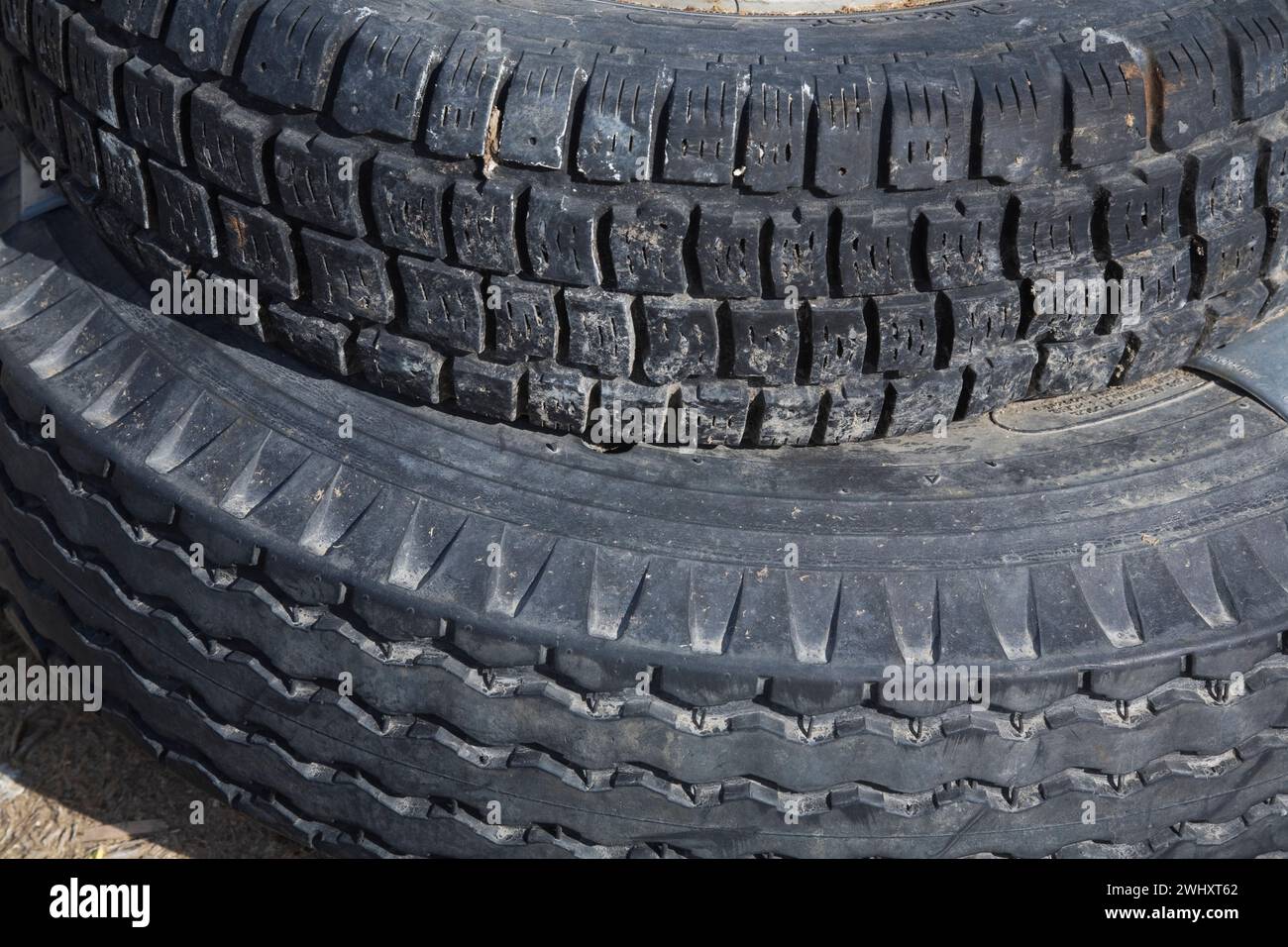 Close-up of black rubber truck tires with worn threads Stock Photo - Alamy