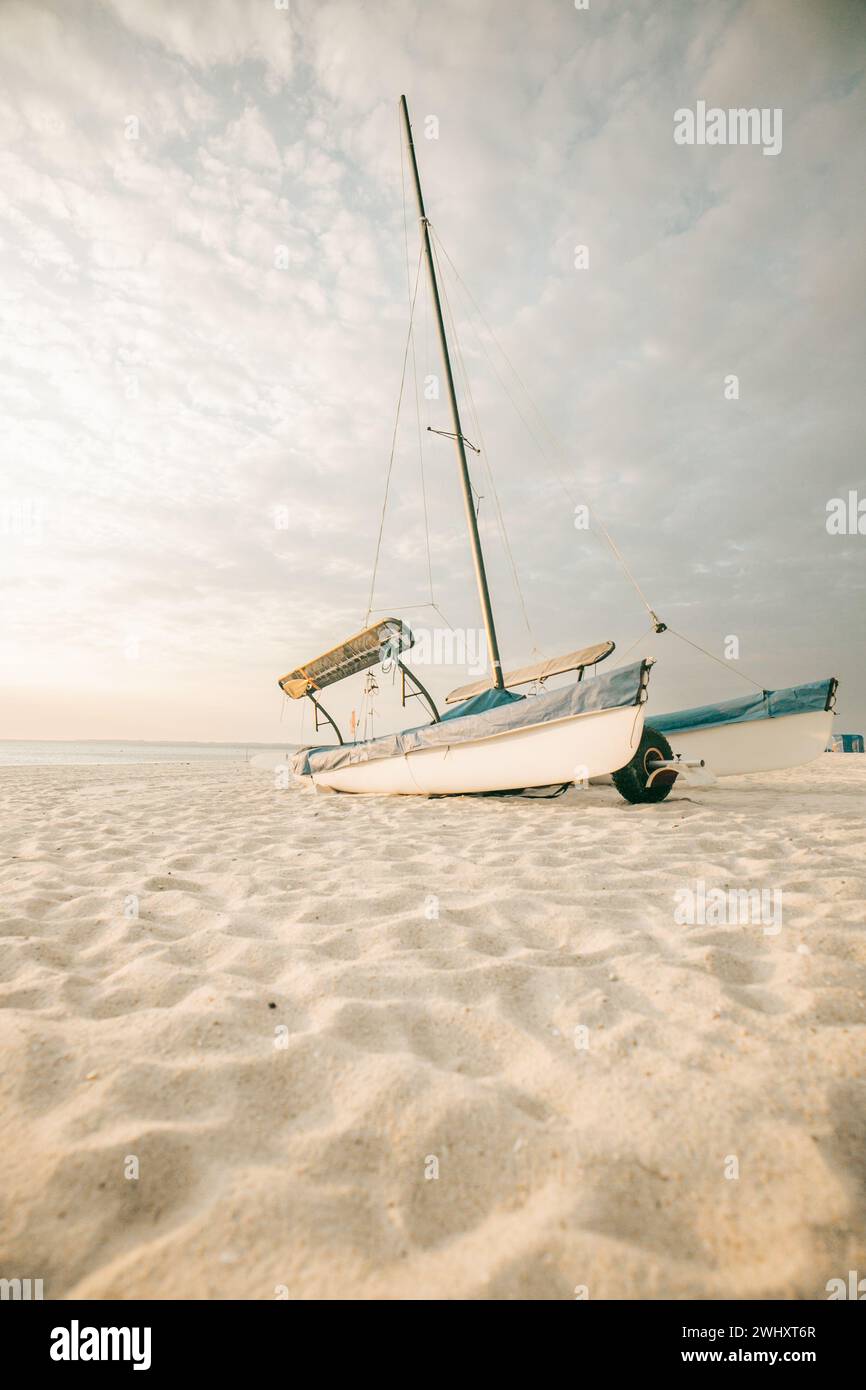 Boat on white sand on the sea coast at sunset.Sea transport. Sandy ...