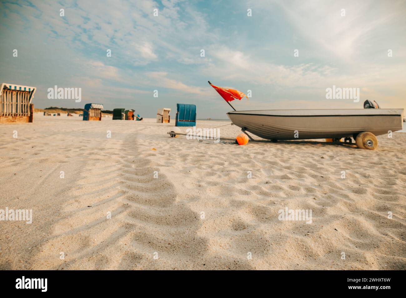 Boats on white sand on the sea coast at sunset.Sea transport. Sandy ...