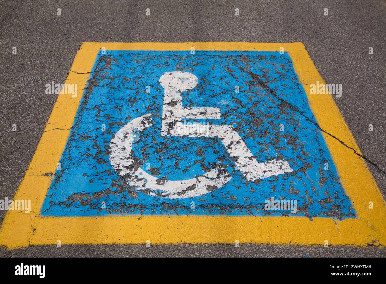 Painted blue and white with yellow frame handicap parking pictogram ...