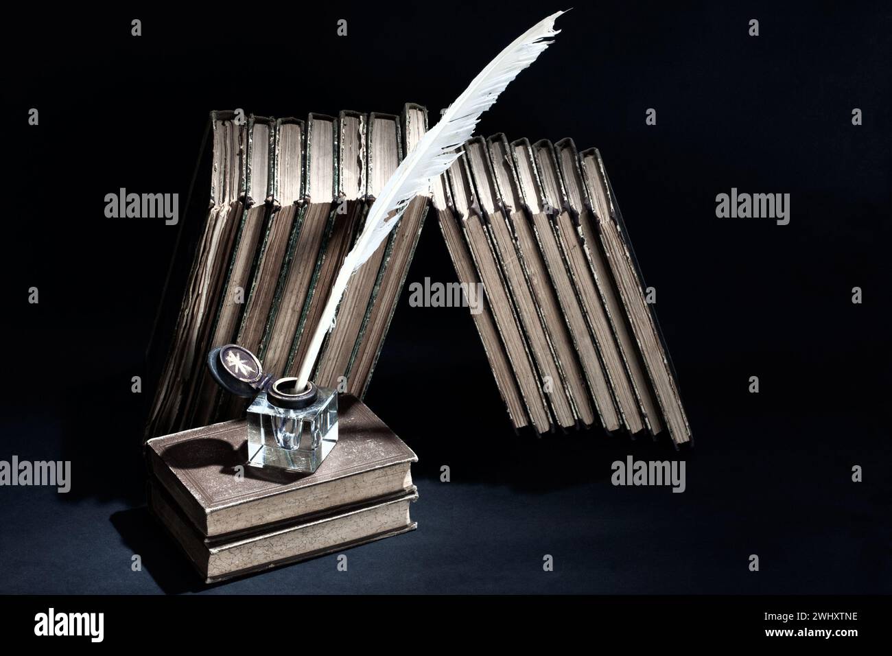 antique books with ink pen and inkpot on black background Stock Photo ...
