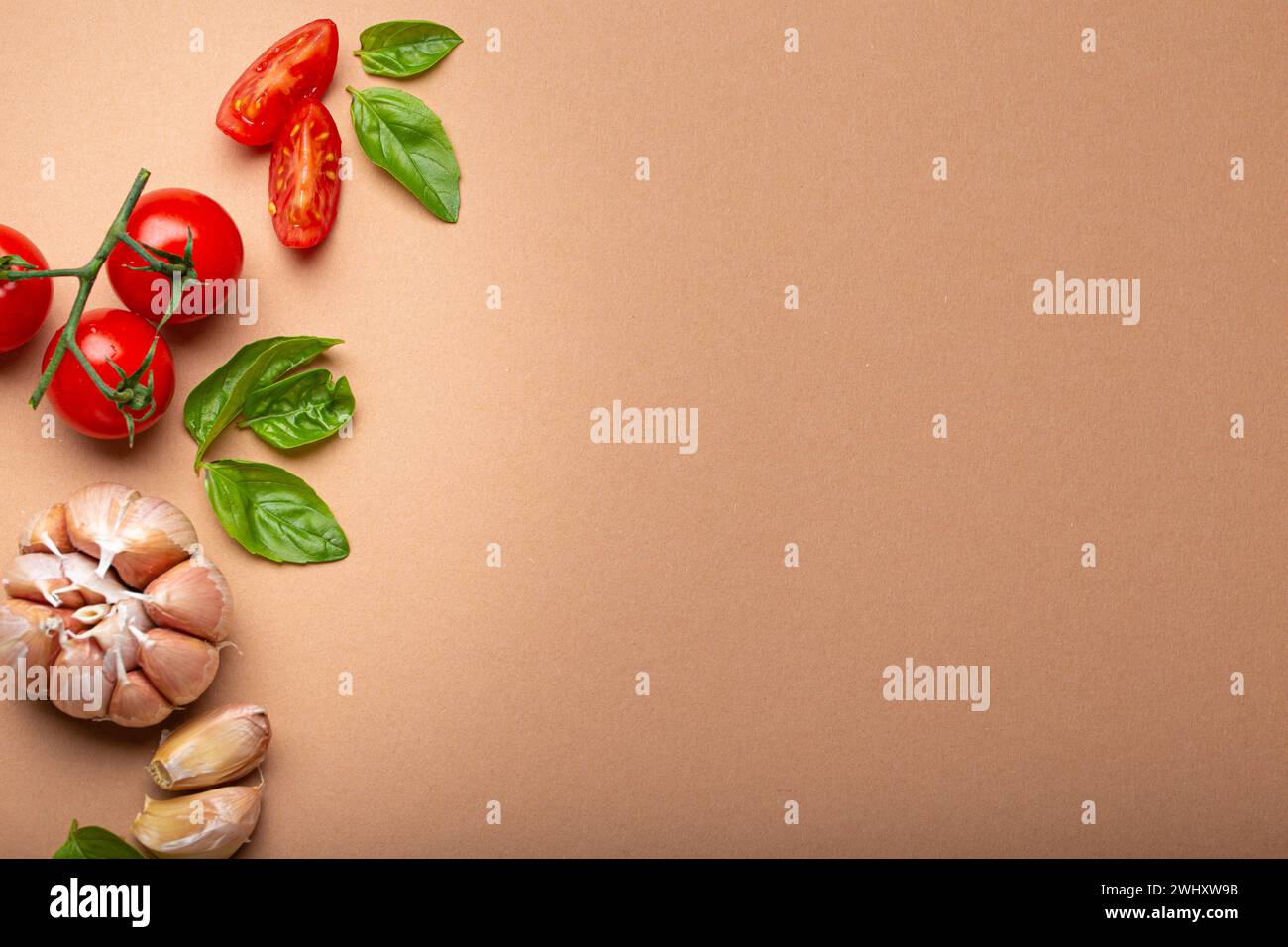 Food cooking border with cherry tomatoes, fresh green basil and garlic ...