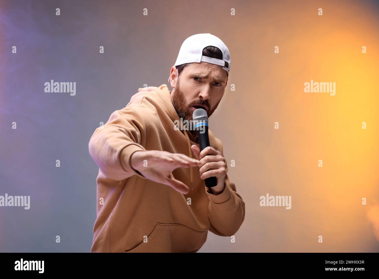 Singer with microphone rapping in color lights Stock Photo - Alamy Singer with microphone rapping in color lights Stock Photo - Alamy