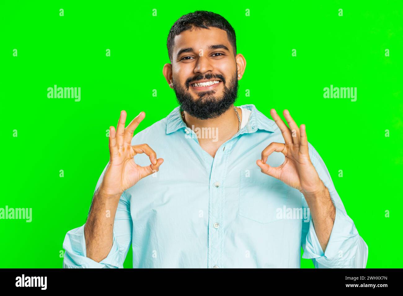 Okay. Happy Indian man looking approvingly at camera showing ok gesture ...