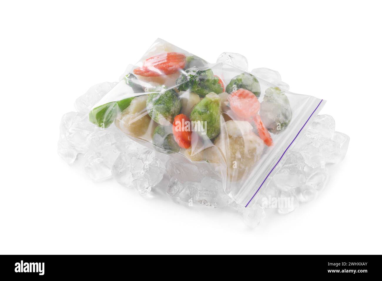 Mix of different frozen vegetables with ice isolated on white Stock ...