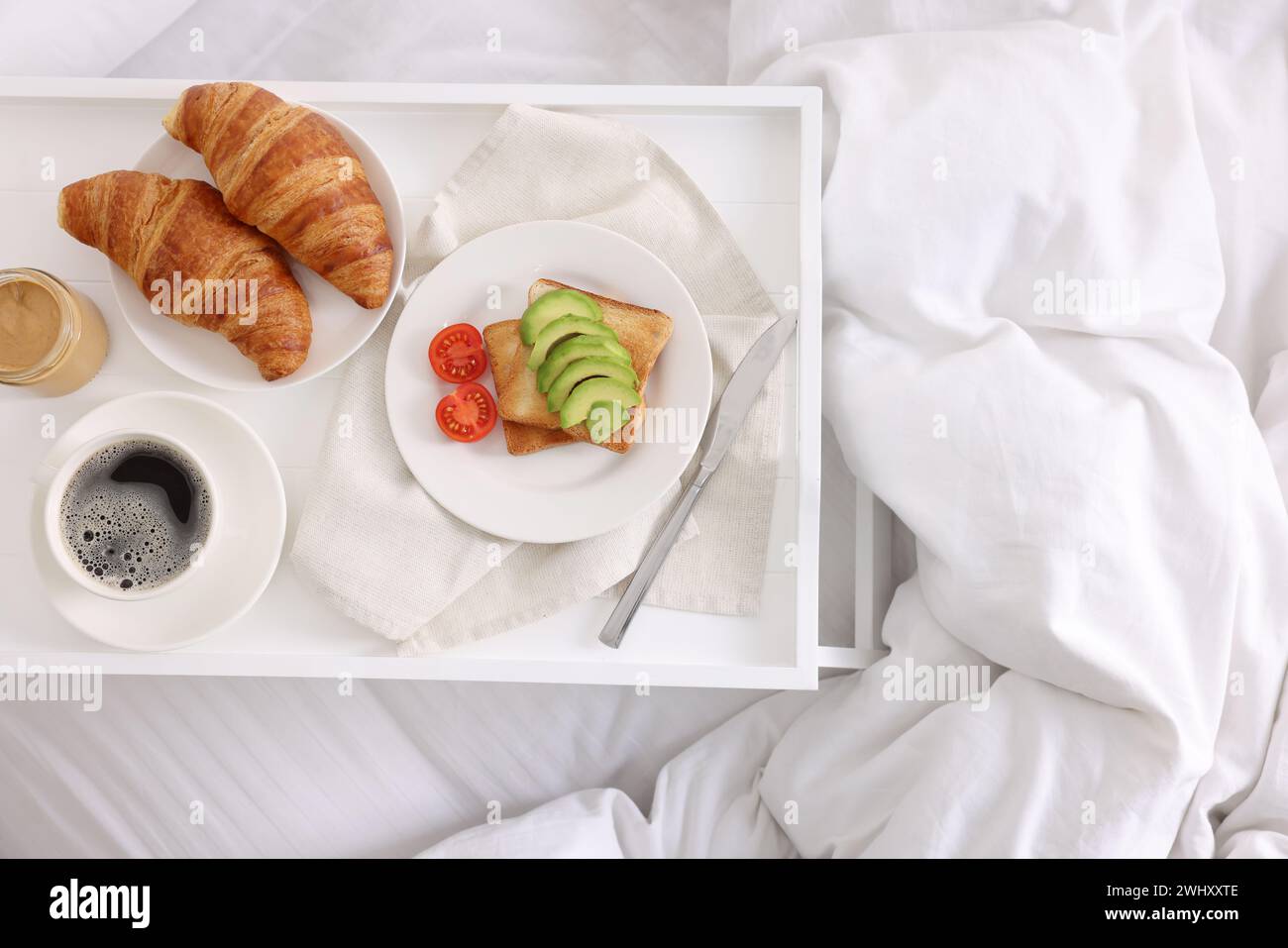 Good morning. Tray with tasty breakfast on bed, top view Stock Photo ...