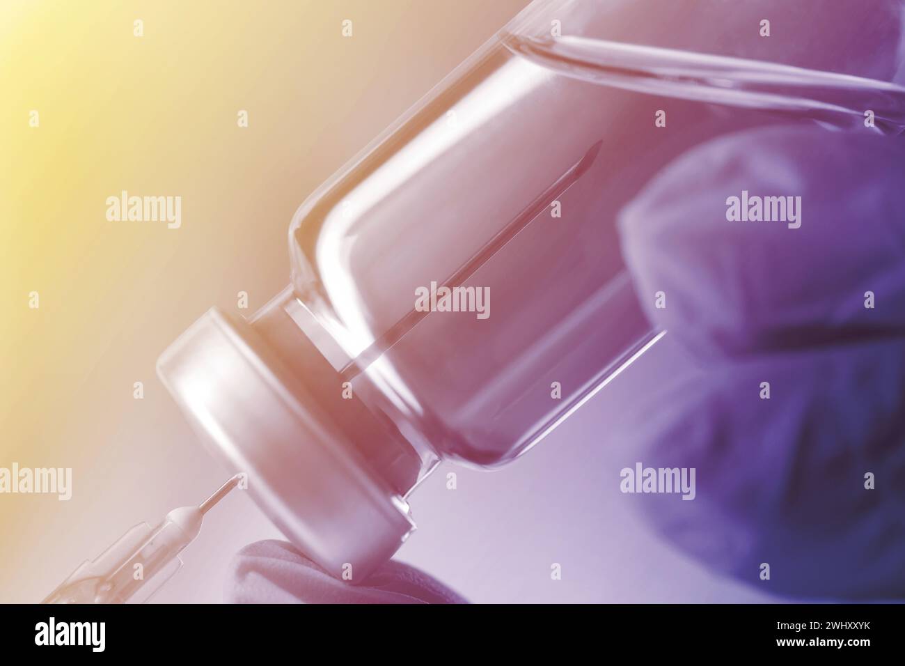 Doctor filling syringe with medication from vial, closeup. Color toned ...