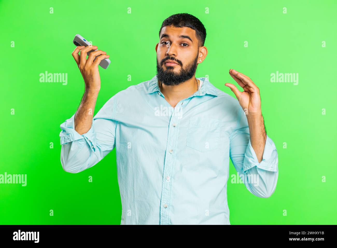 Disinterested Indian man having annoyed boring talk on smartphone ...