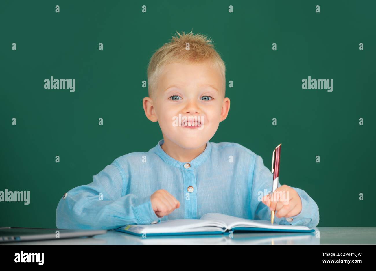 Back to school. Kid writing in class. Little student child studying in ...