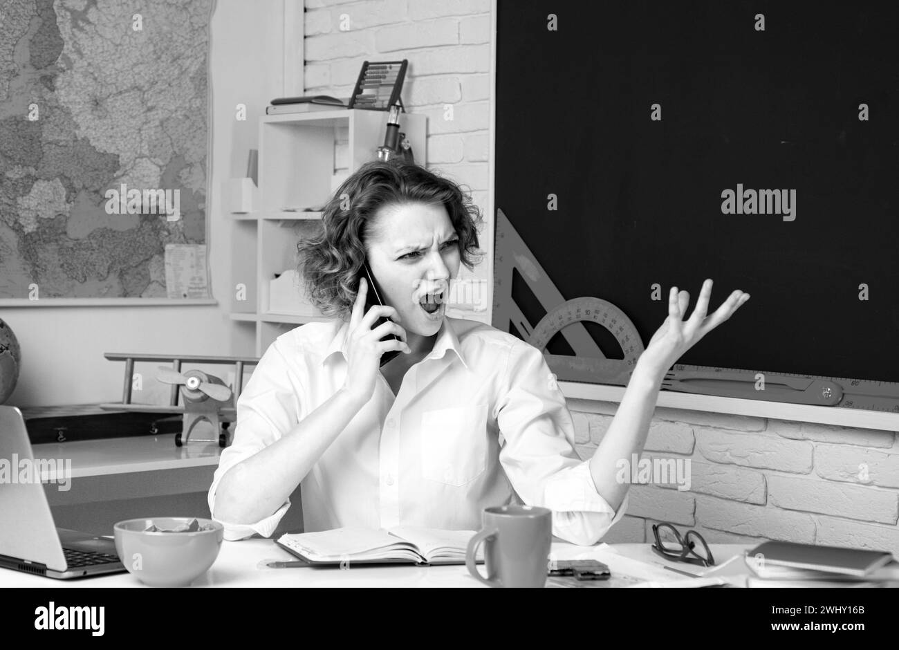 Education concept. School teacher talking on smartphone. Angry tutor in ...