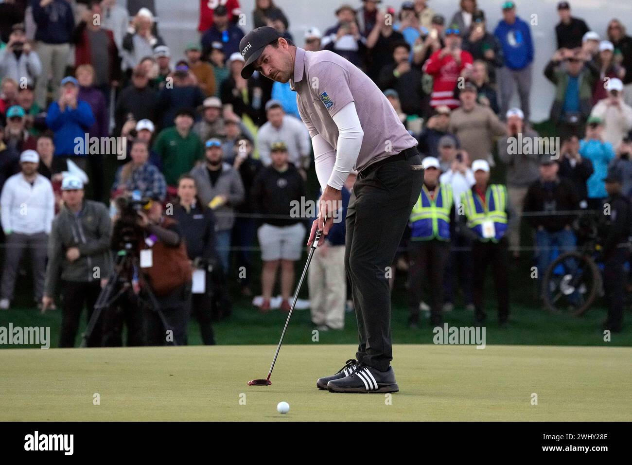 Nick Taylor, of Canada, hits a winning putt against Charley Hoffman on ...