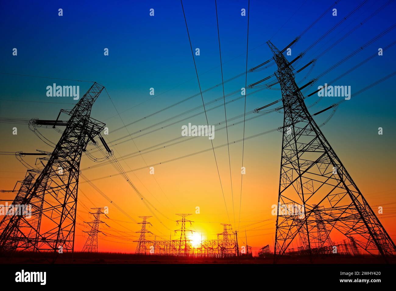 Pylon, high-voltage tower sky background Stock Photo - Alamy