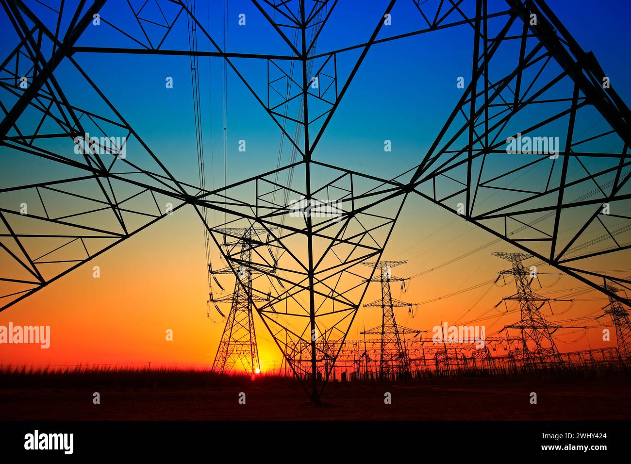 Pylon, high-voltage tower sky background Stock Photo - Alamy