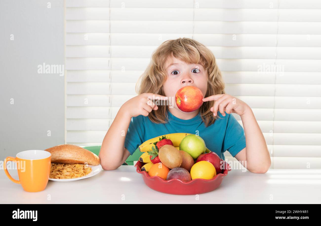 Funny child eating apple. Kid preteen boy 7, 8, 9 years old eating ...