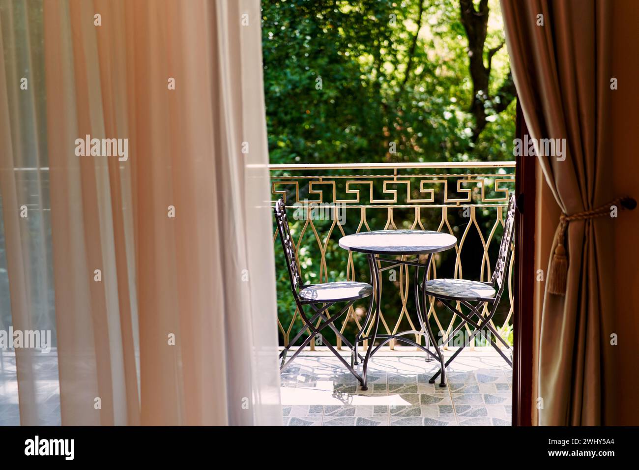 View from the window to the terrace with a table and chairs on it Stock ...