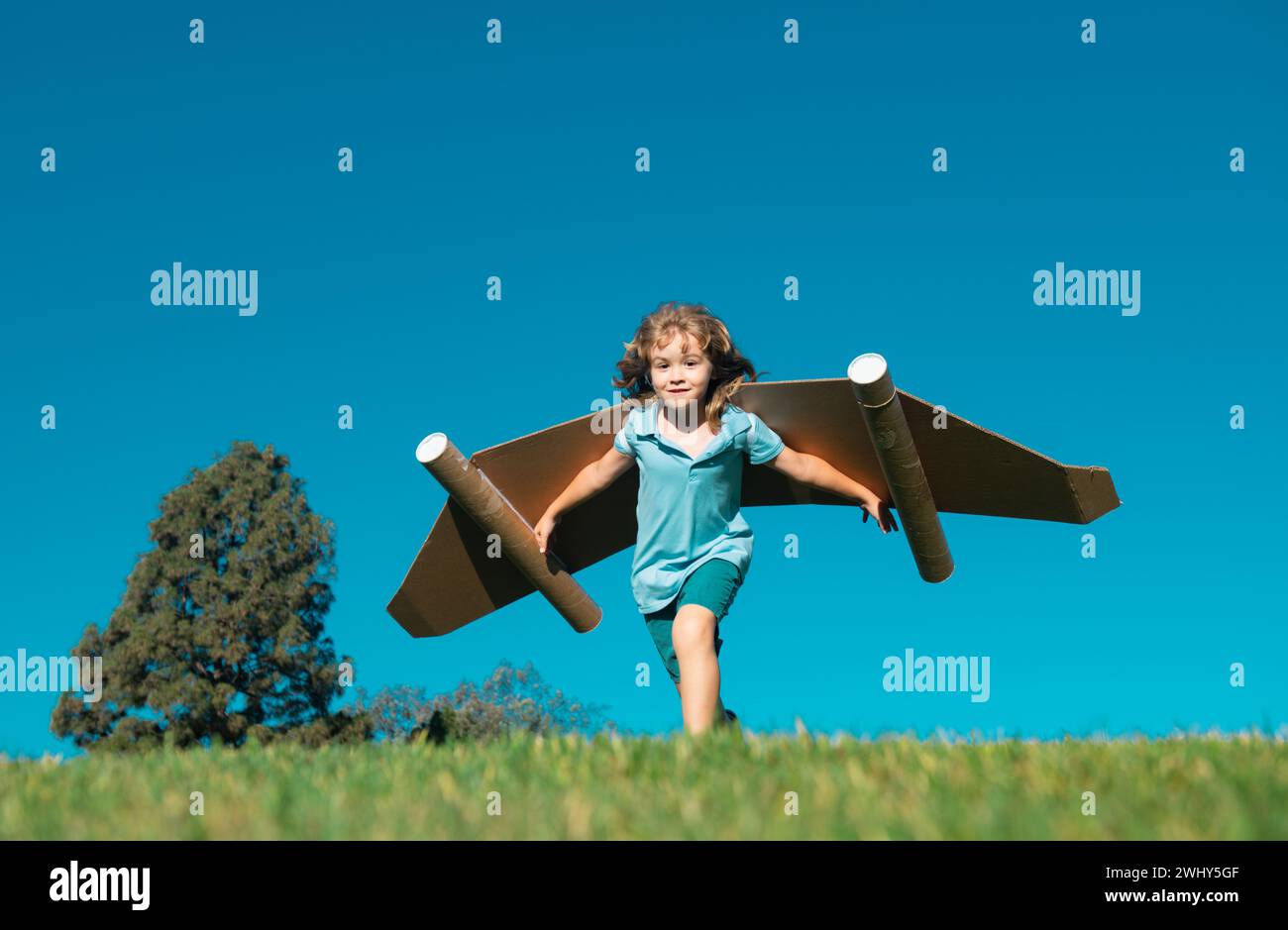 Boy child with wings at sky imagines a pilot and dreams of flying. Kids ...