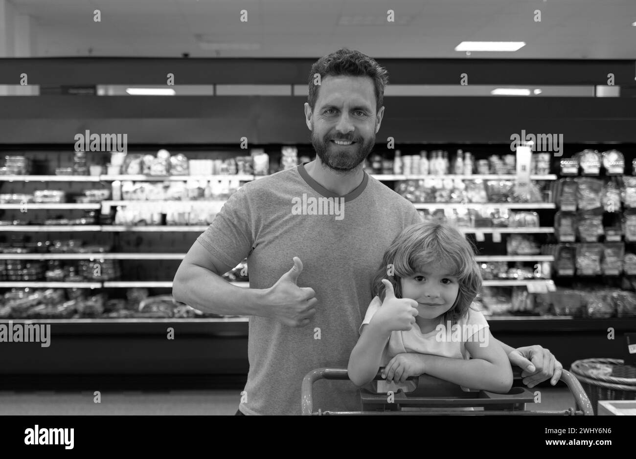 Father and son buy fresh vegetable in grocery store with thumbs up ...