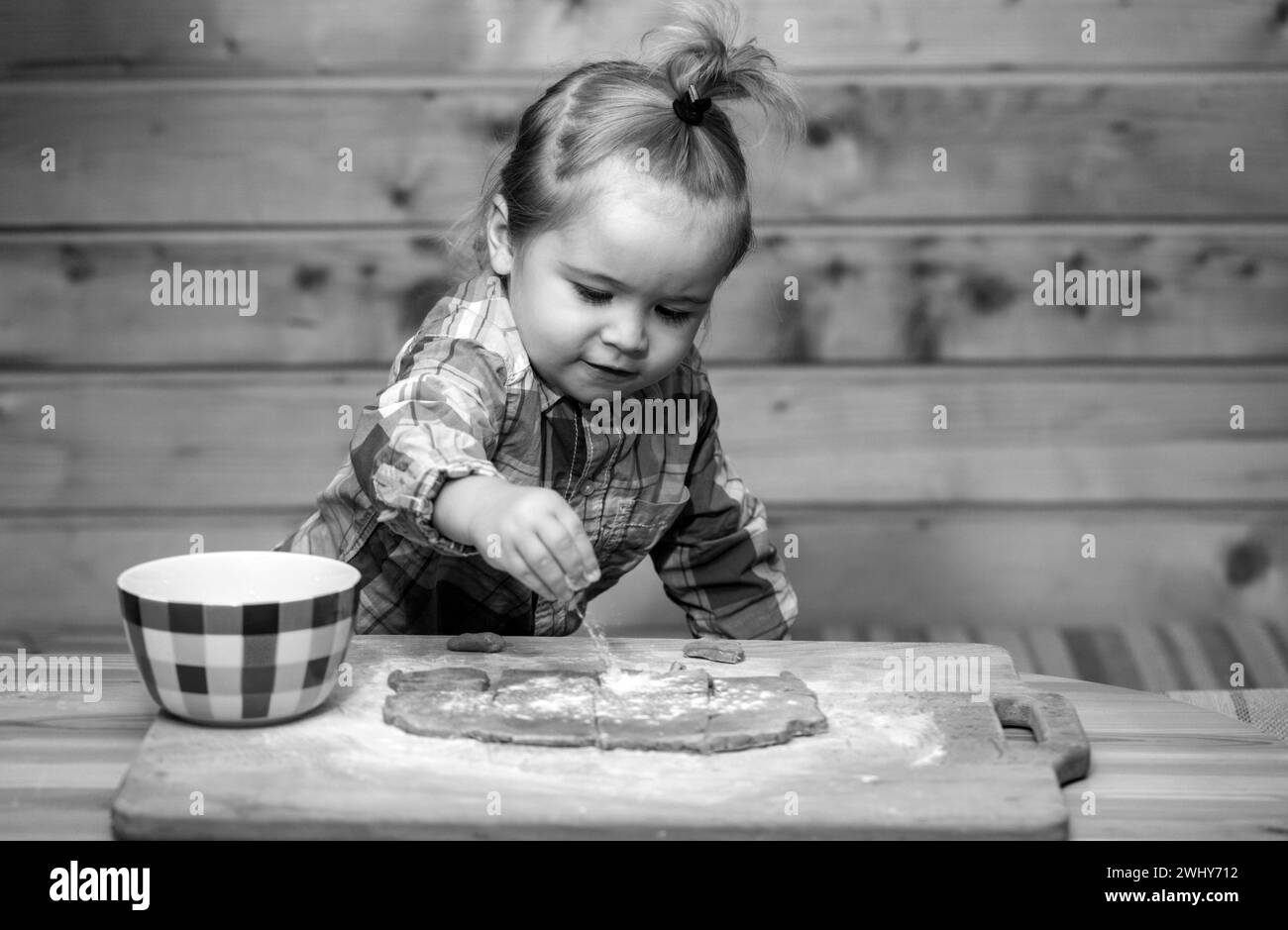 Fun image of baby chef play with flour on wooden kitchen background ...