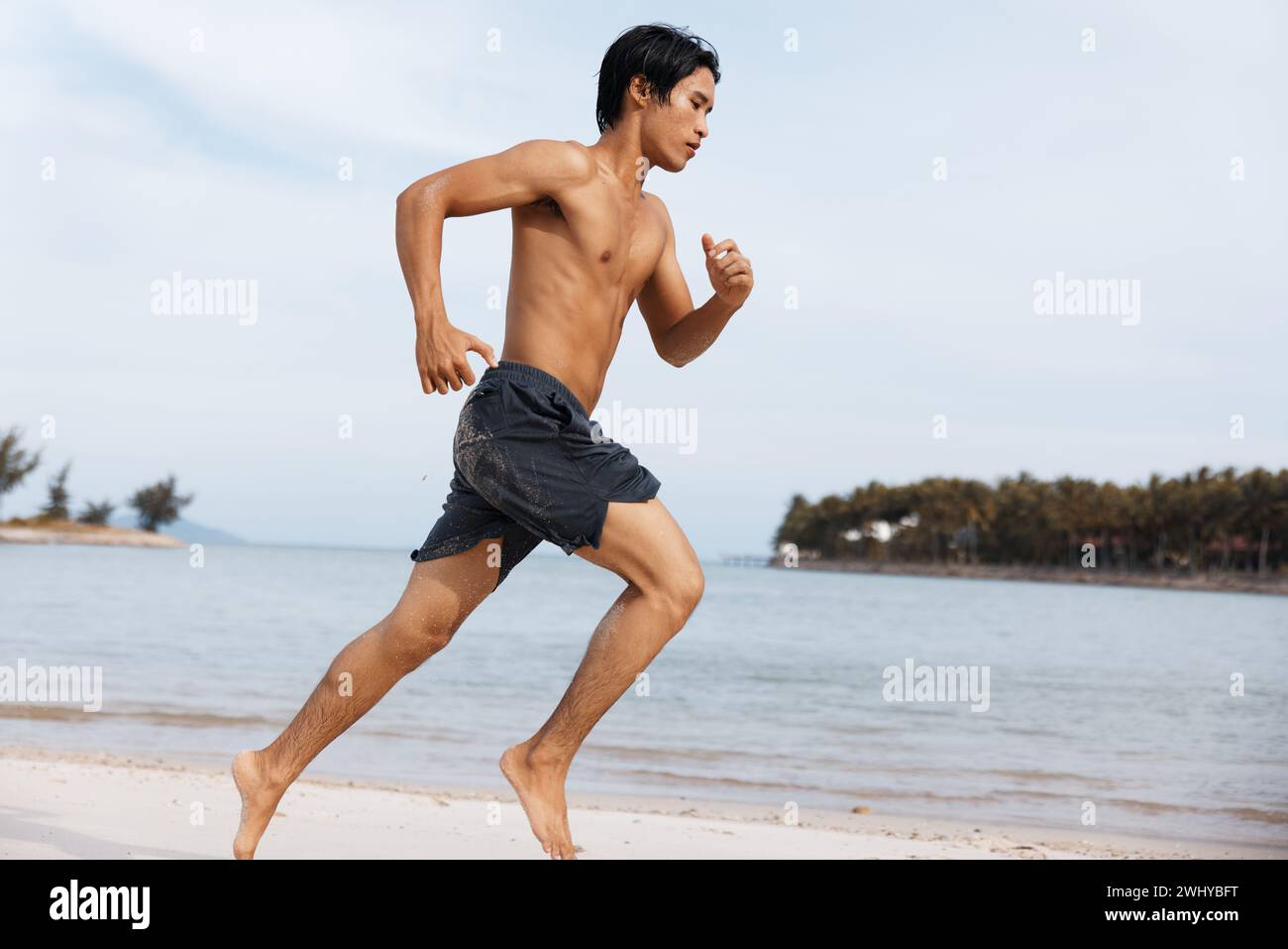 Active Asian Athlete Enjoying a Sunset Beach Run: Strong, Muscular Man ...