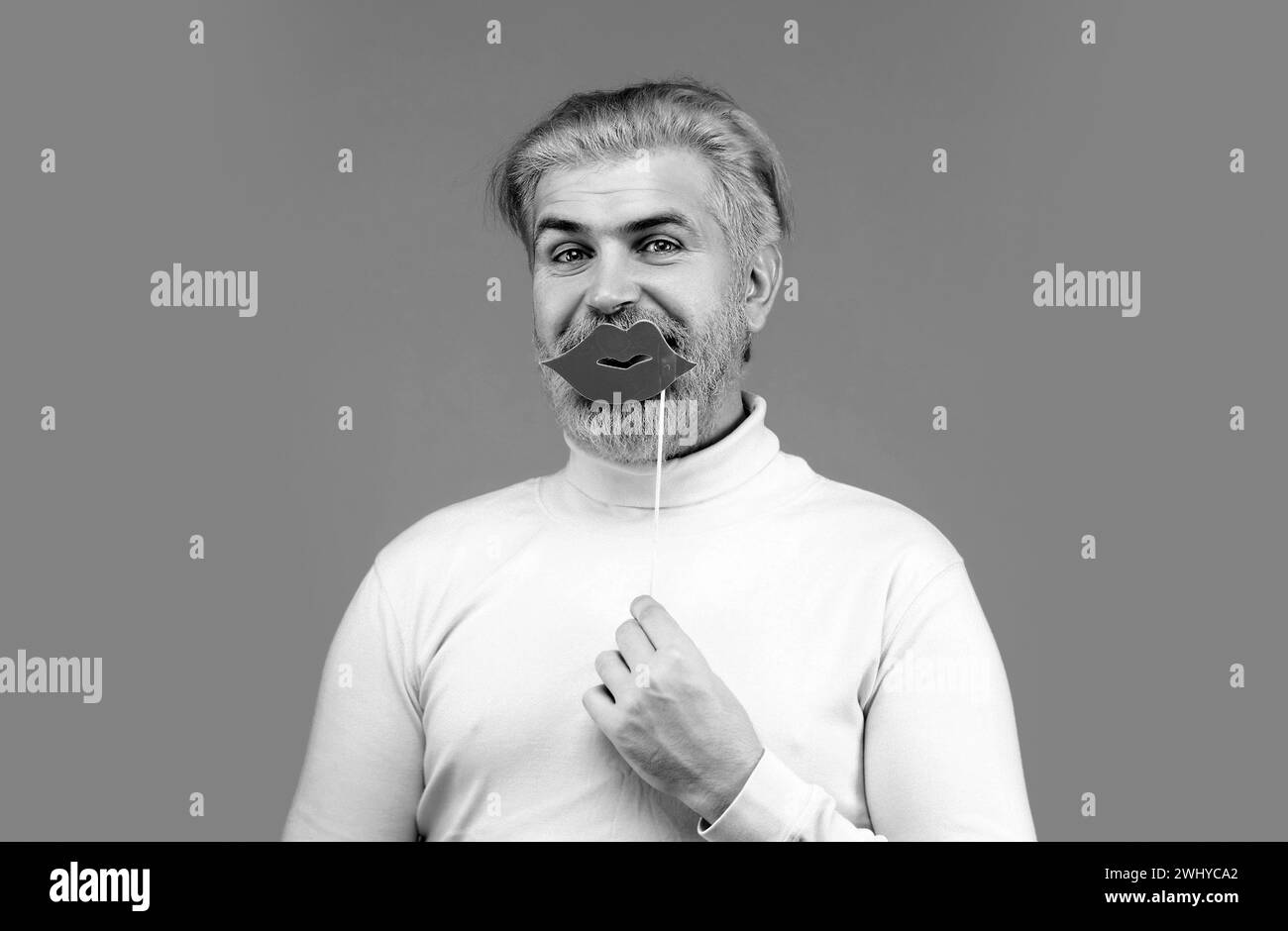 Photo booth concept. Man holding party lips. Bearded man with ...