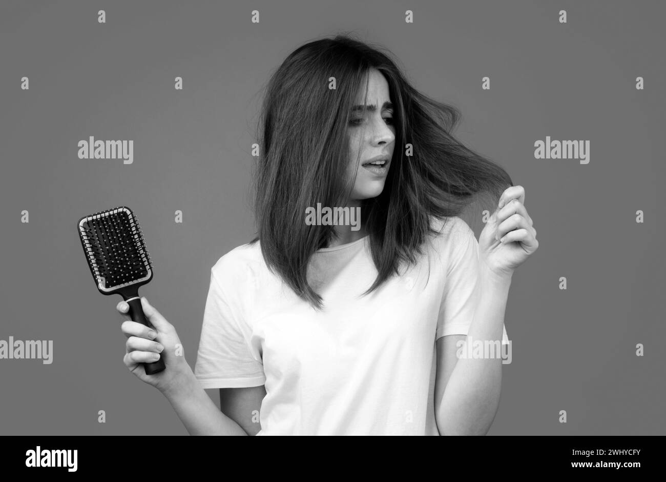 Woman with hair problem. Woman is looking shocked to her lost hair ...