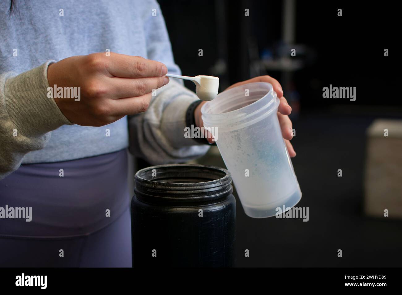 Person pouring protein powder cup hi-res stock photography and images ...