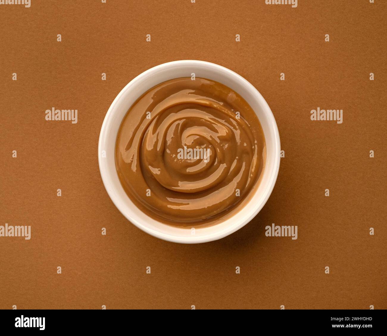 Boiled condensed milk, bowl of melted caramel cream, top view Stock ...