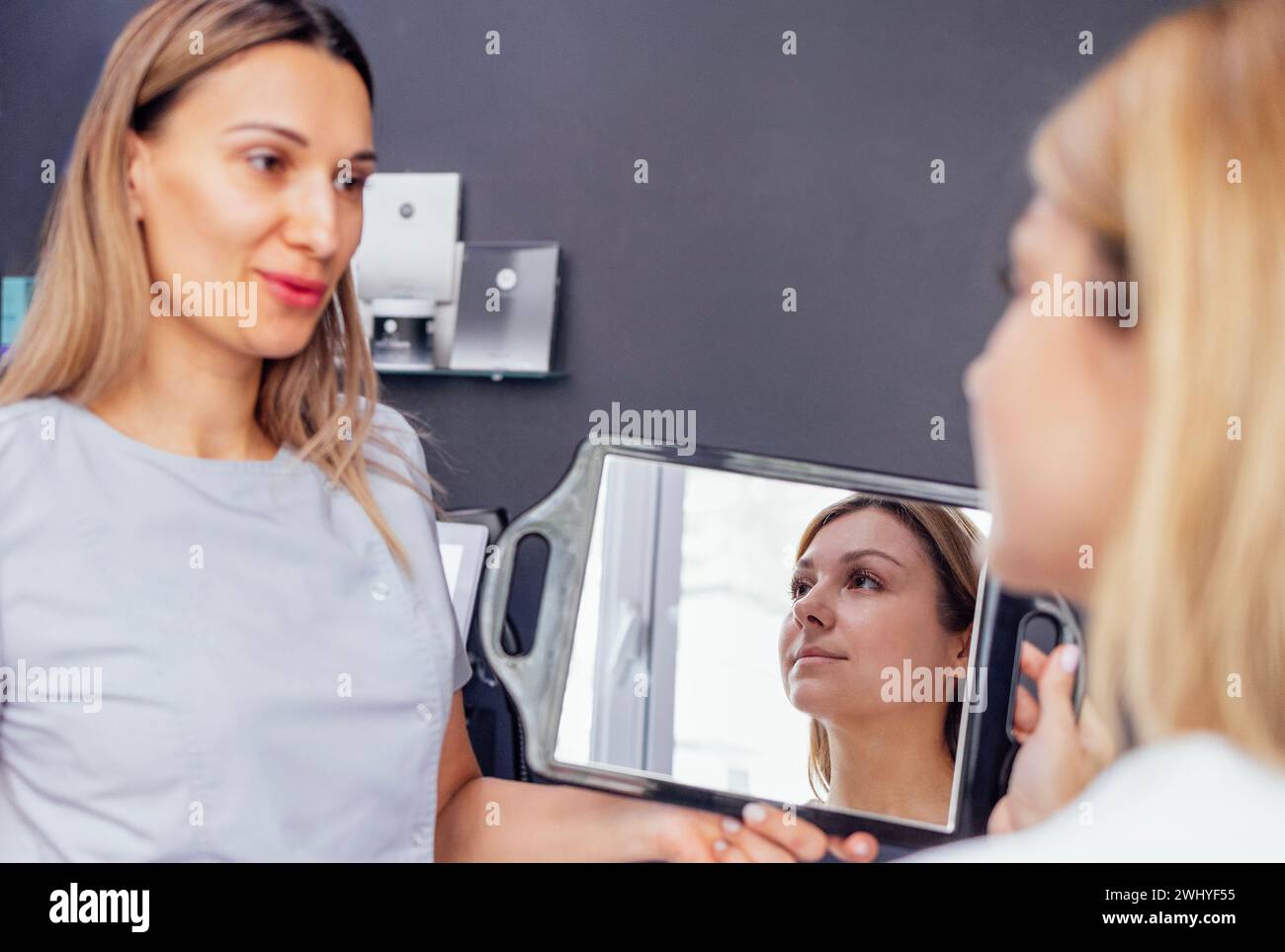 Doctor checking woman face skin in cosmetology clinic before plastic ...