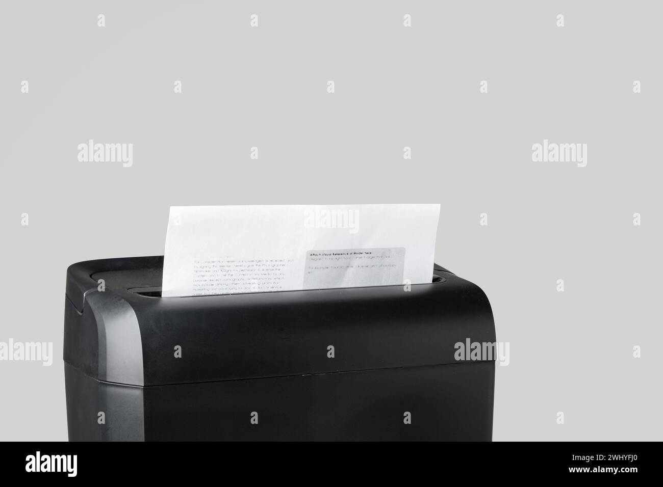 Office paper shredder on table against gray background Stock Photo - Alamy