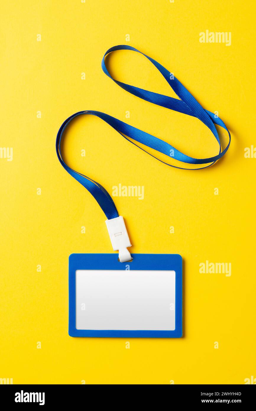 Blank nametag on a string on yellow background copy space Stock Photo ...