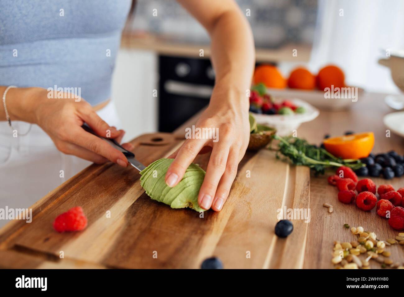 An attractive cute Asian woman smiles and cooks breakfast in the ...