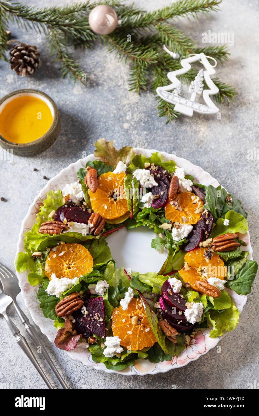 Christmas appetizer. Christmas wreath salad with beetroot, tangerines ...