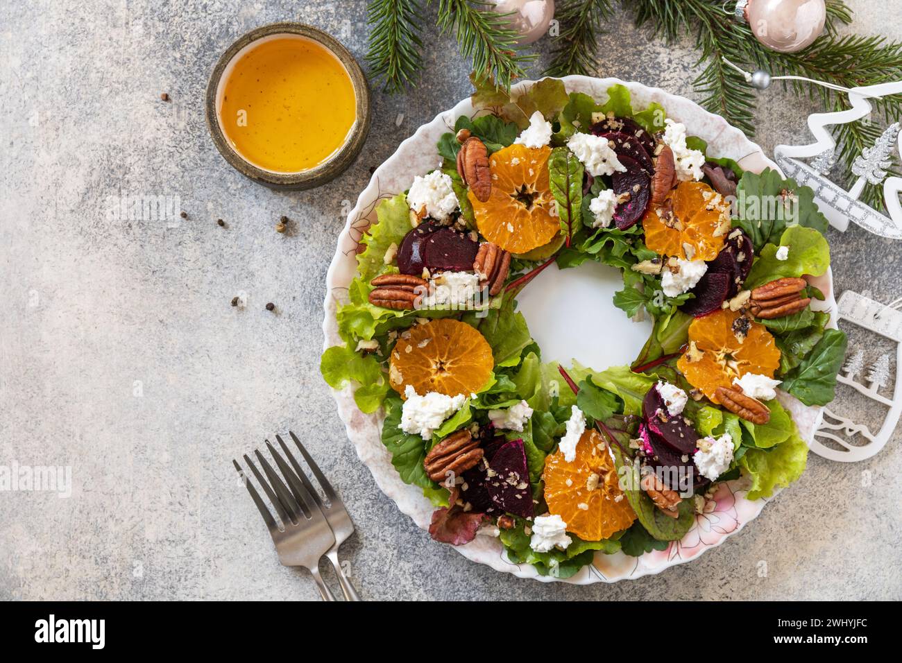 Christmas appetizer. Christmas wreath salad with beetroot, tangerines ...
